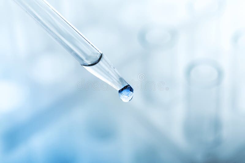 Pipette with a Drop and Scientific Laboratory Test Tubes in a Research ...
