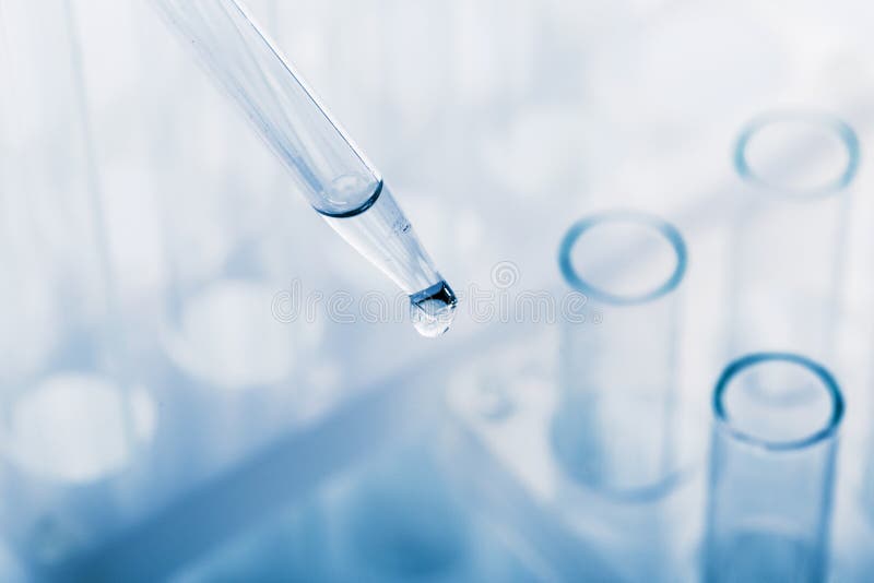 Pipette with a Drop and Scientific Laboratory Test Tubes in a Research ...