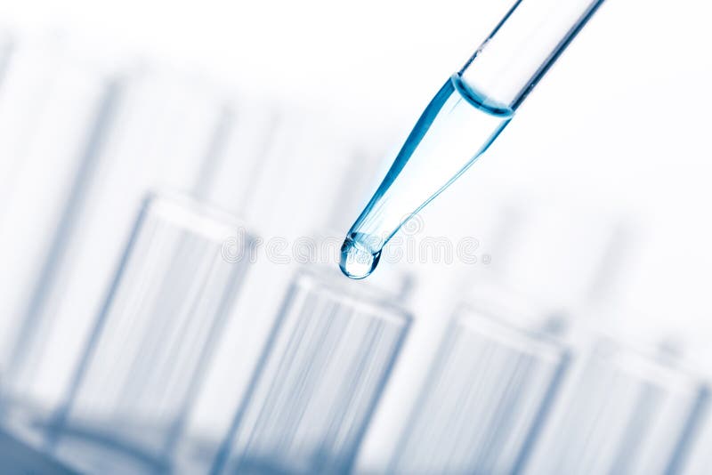 Pipette with a Drop and Scientific Laboratory Test Tubes in a Research ...