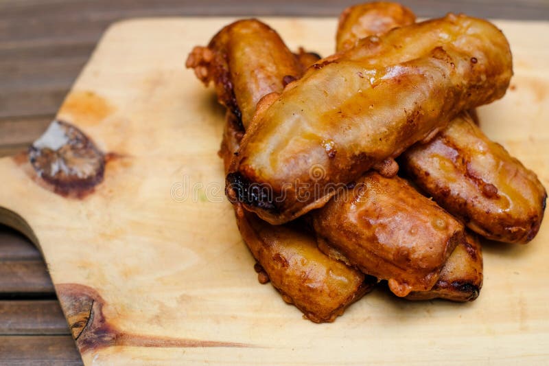 Pisang Goreng, or Fried Bananas on Wooden Cutting Board, is a Popular ... Pisang Goreng, or Fried Bananas on Wooden Cutting Board, is a Popular ...