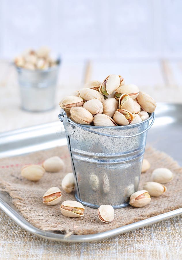 Pistachio nuts in a bucket stock photo. Image of protein - 55548648