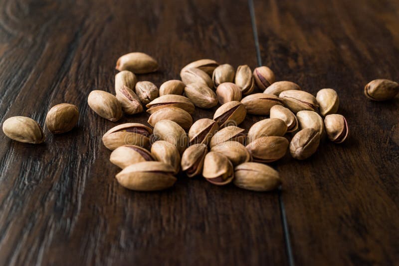 Pistachio Nuts with Shell on Dark Wooden Surface Stock Photo - Image of ...