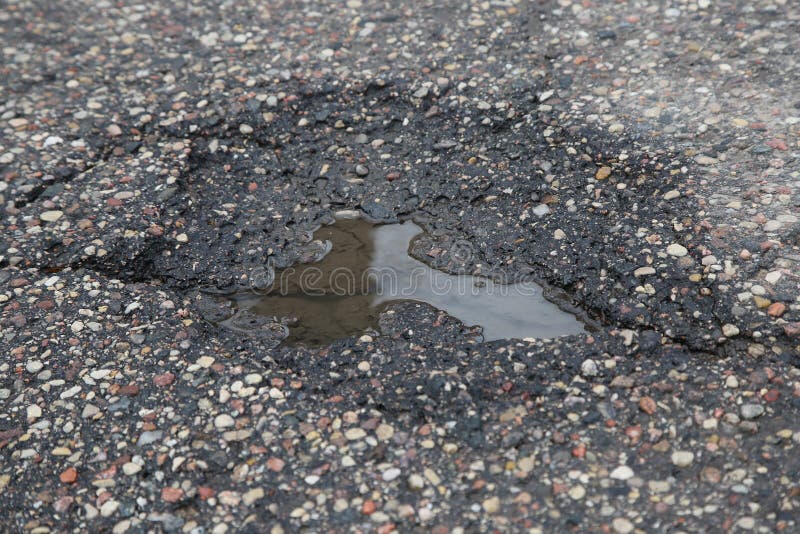 The Pit on the Asphalt Road with Puddle Stock Image - Image of ...
