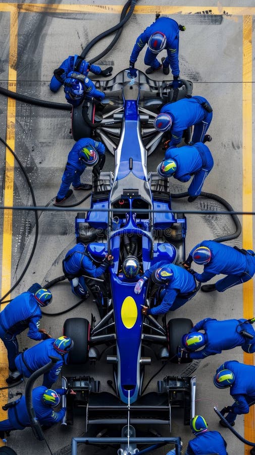 Pit Crew Precision. Team in Blue Suits Works Meticulously on Race Car ...