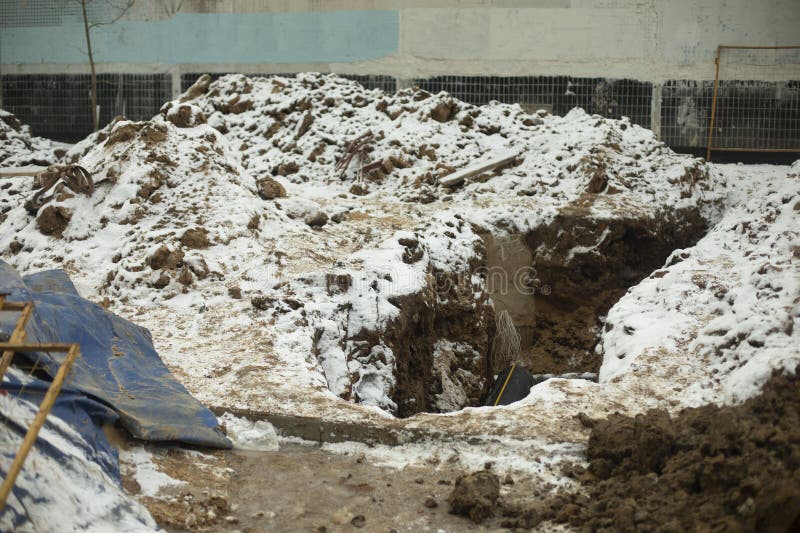 Pit for Laying Heating Pipes in Winter. Dug Frozen Ground in Yard Stock ...