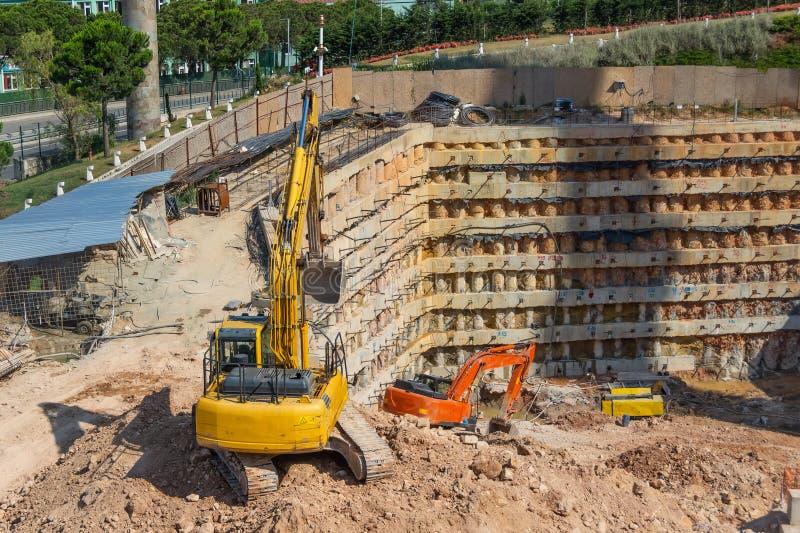 Pit of a Metro Station with Piles in the Ground, Working Excavators Dig ...