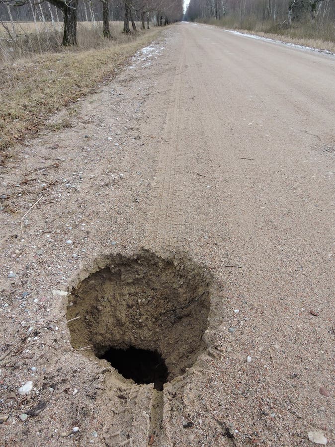 Deep pit on the road stock photo. Image of dangerous - 115083964