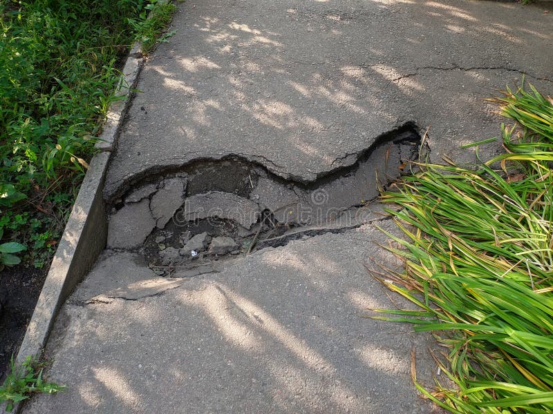 Pit on the Sidewalk Close-up. a Hole in the Asphalt is an ...