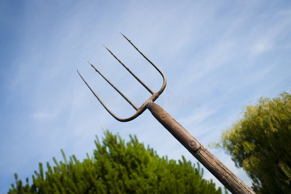 Pitch fork held aloft stock image. Image of pitch, devil - 15889701