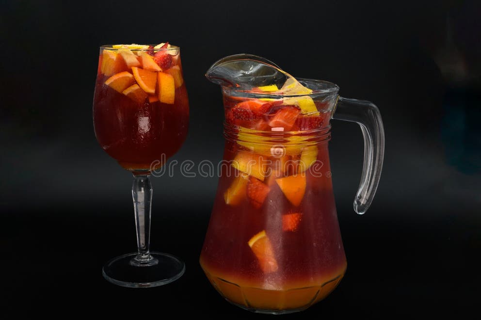 A Pitcher of Fruit Punch is Poured into a Glass Stock Photo - Image of ...