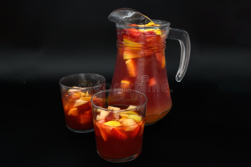 A Pitcher of Fruit Punch is Poured into Two Glasses Stock Image - Image ...