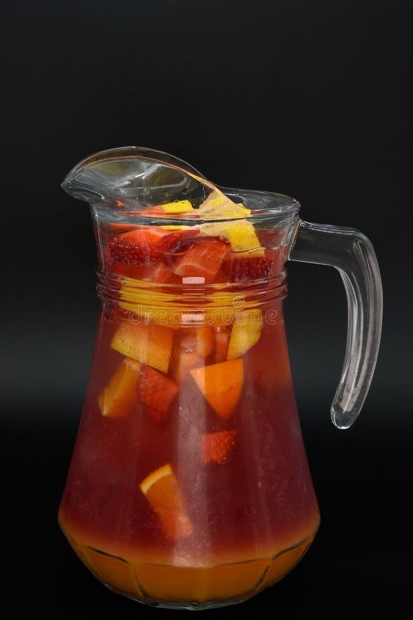 A Pitcher of Fruit Punch is Sitting on a Black Table Stock Image ...