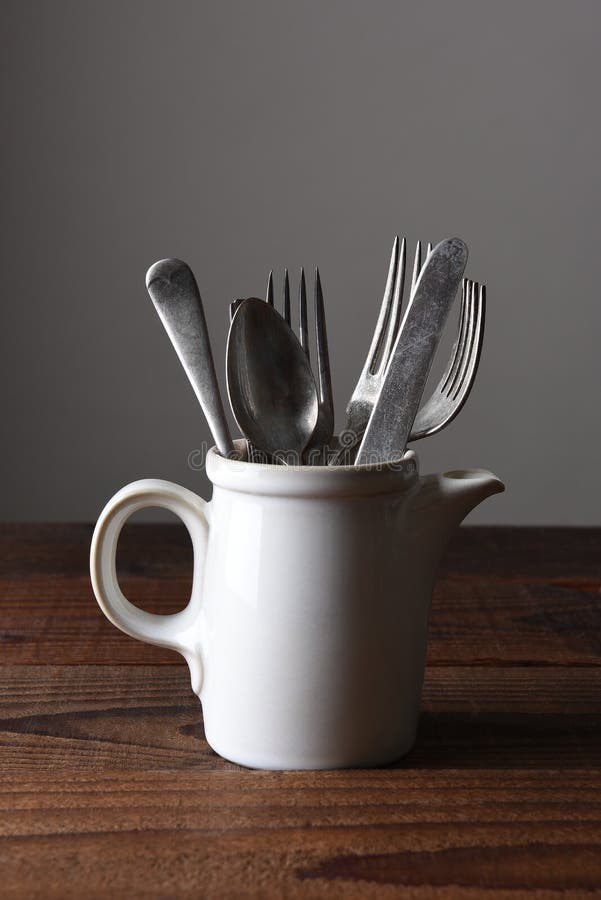 Pitcher Full of Silverware stock image. Image of light - 93595887
