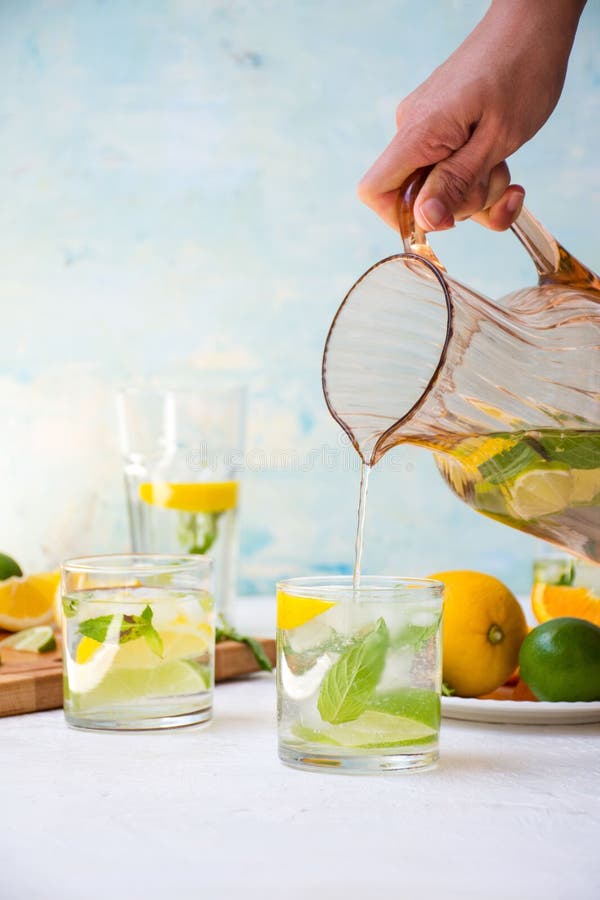 Pitcher of Ice-cold Lemonade Being Poured into a Glass. Stock Photo ...