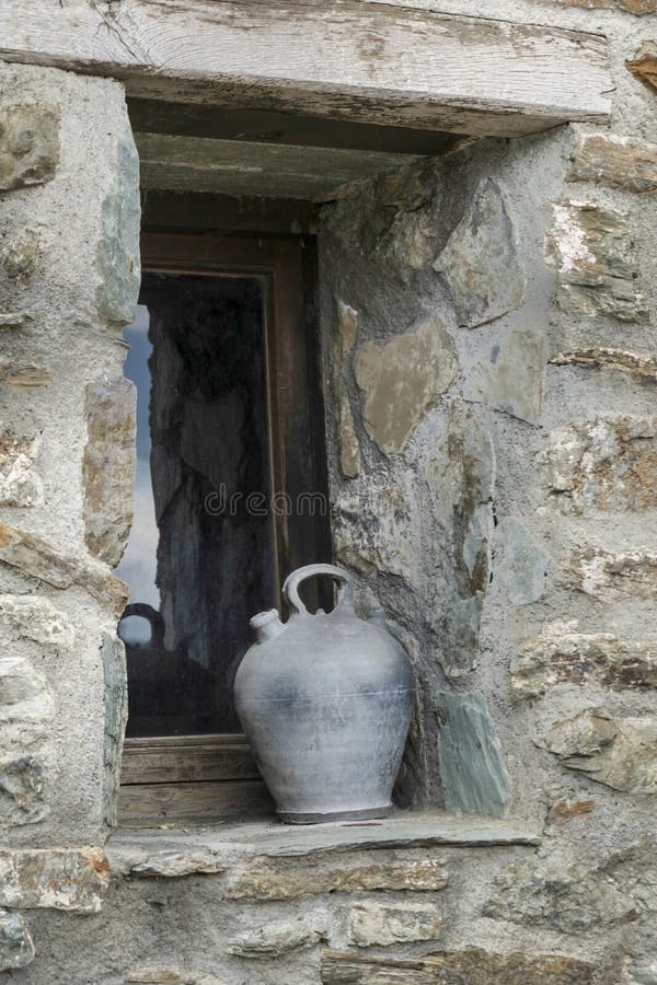 Pitcher in a stone window. stock photo. Image of traditional - 123389858