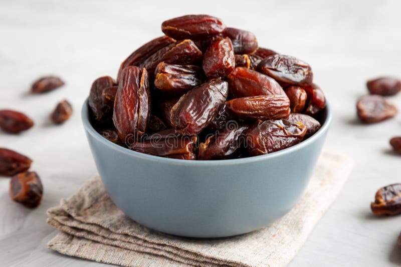 Pitted Organic Dates in Bowl on Gray Background, Side View Stock Photo ...