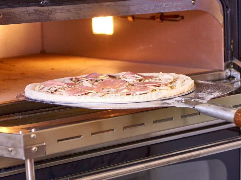 Pizza baking in the oven stock photo. Image of culture - 179967532