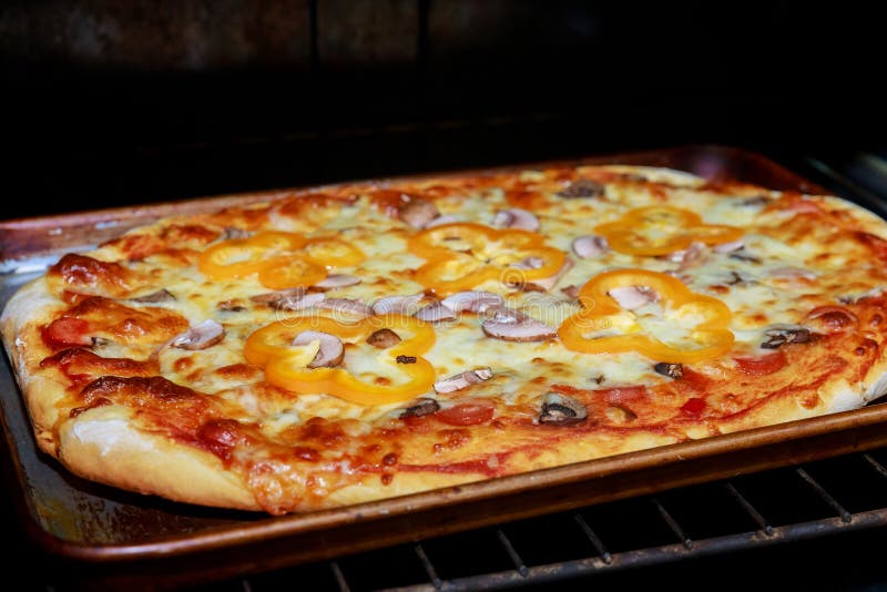 Pizza baking in the oven stock image. Image of baker - 107852421