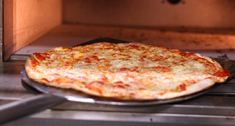 Pizza baking in an oven stock photo. Image of electric - 144705310