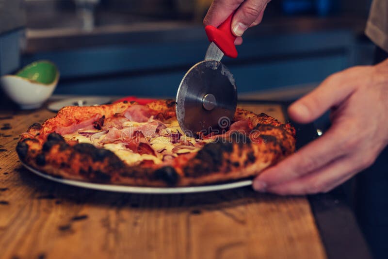 Pizza Being Cut by Pizza Cutter. Close Up of Crust and Pizza Stock ...