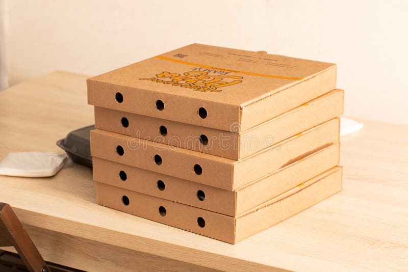 Pizza Box: Tall Stack, Brown on Dining Table Stock Photo - Image of ...