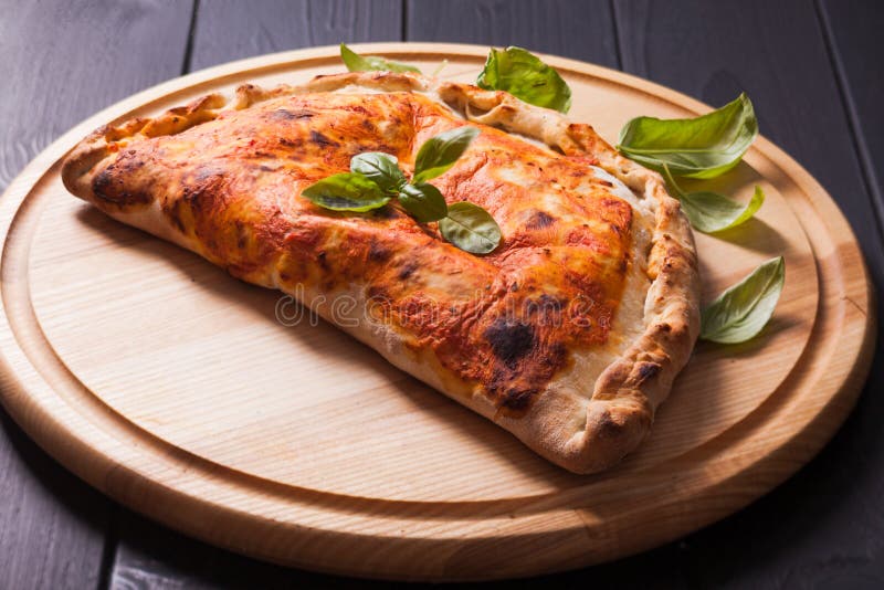 The Pizza calzone stock photo. Image of golden, tasty - 62820052
