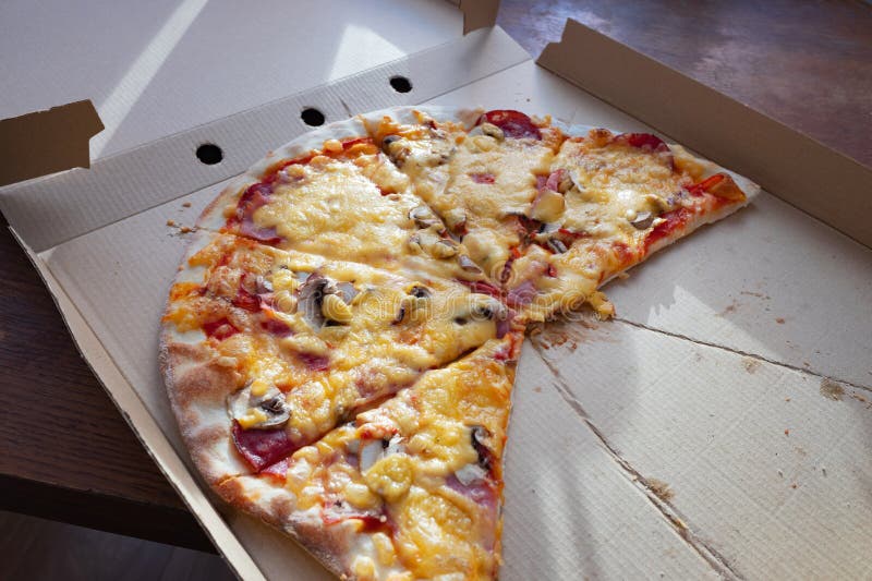 An almost Half Eaten Takeaway Pizza in a Cardboard Box Stock Image ...