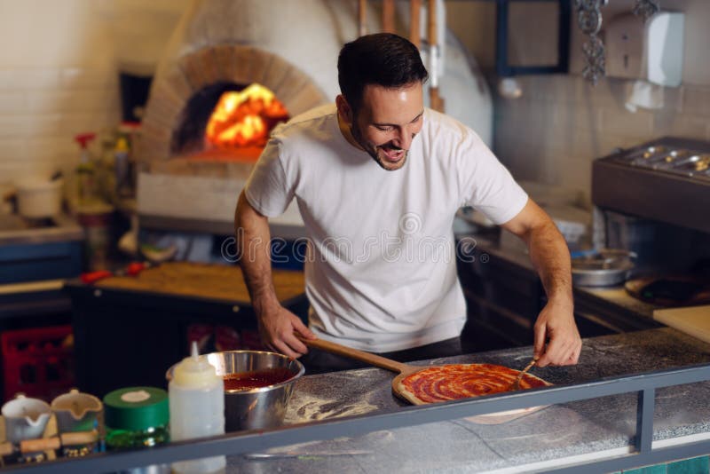 Pizza Chef Puts Pizza in the Oven To Bake in the Oven in the Restaurant ...