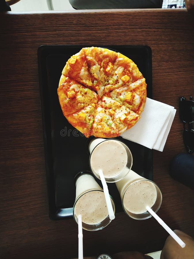 Pizza with cold coffee stock photo. Image of produce - 188975456
