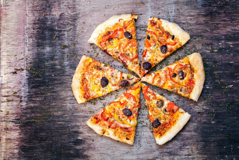 Pizza cut into slices stock photo. Image of partition - 42426956