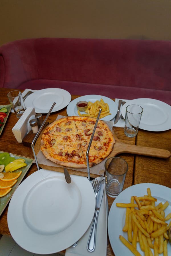 Pizza and Fried Potatoes on White Plates. Festive Table Setting Stock ...