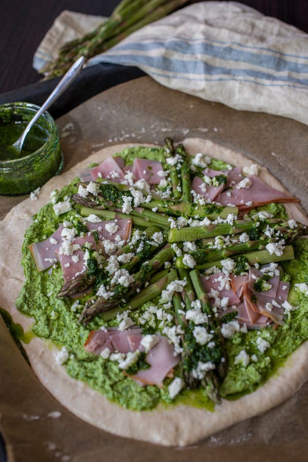 Pizza with Green Asparagus, Peas and Cheese on a Rustic Stock Photo ...