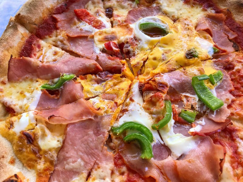 Pizza with Ham, Bacon, Tomatoes, Onion Eggs and Pepper Stock Image ...