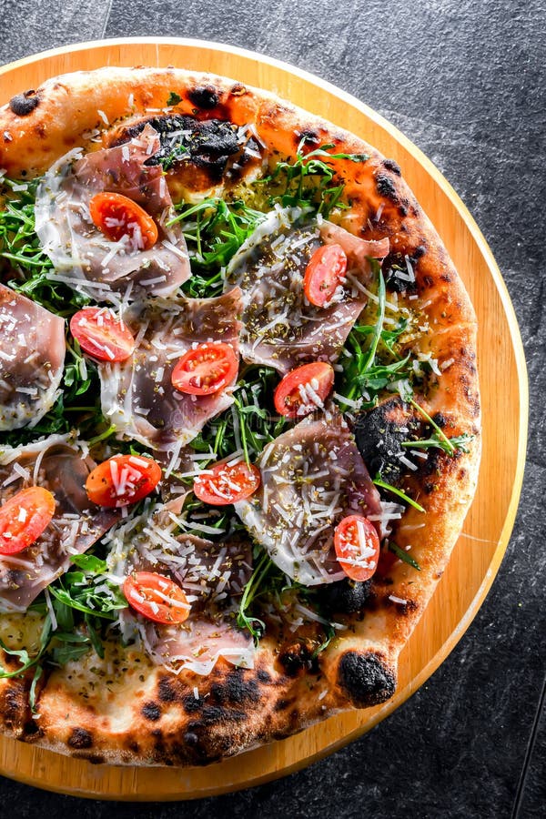 Pizza Italiana Served with Ham, Cheese, Tomatoes and Rucola Stock Photo ...