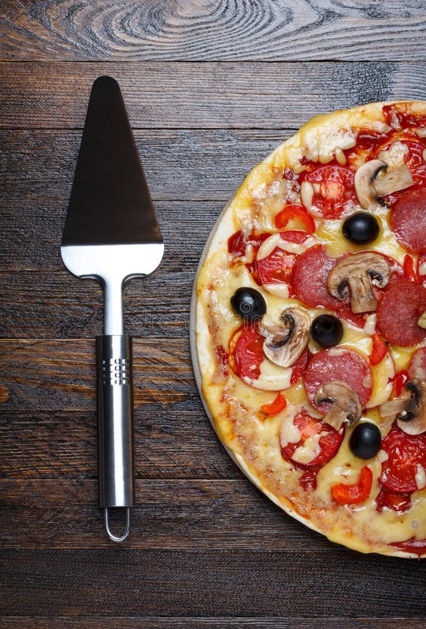 Pizza with lifter stock photo. Image of olive, spoon - 27025896