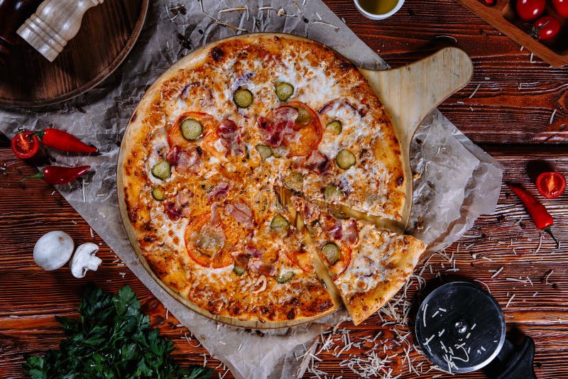 The Pizza is on the Kitchen Table, and the Ingredients are Scattered ...