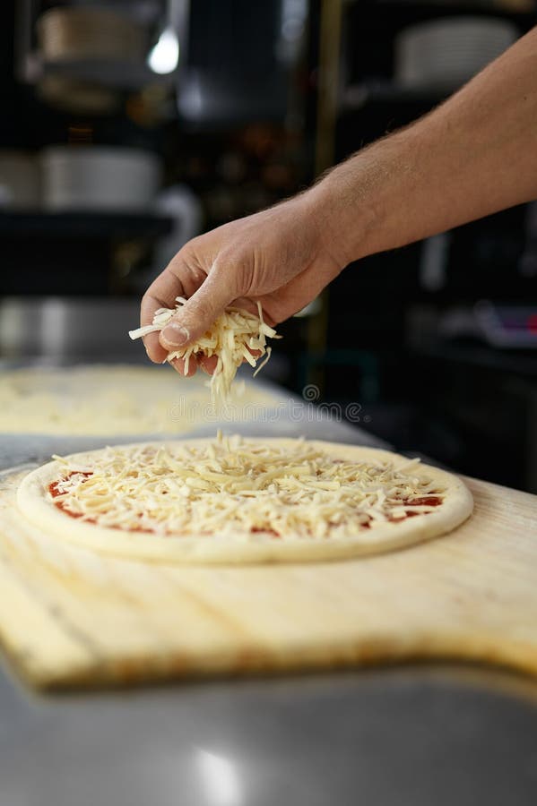 Pizza Preparation Process with Closeup Chef Hands Sprinkling Cheese ...