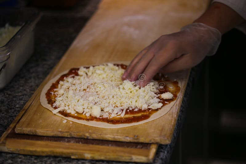 Pizza Preperation. Adding Cheese on Pizza Stock Image - Image of chef ...