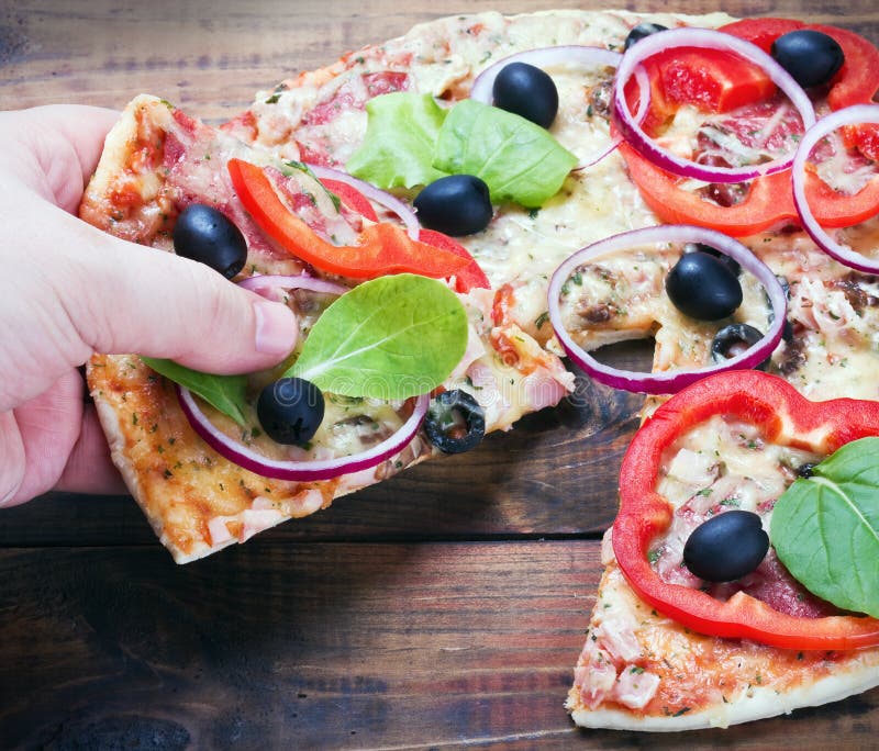 Pizza and Slice of Pizza in Hand Stock Image - Image of close, garden ...