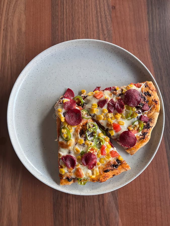 Pizza slices on a plate stock image. Image of food, sausage - 352571847