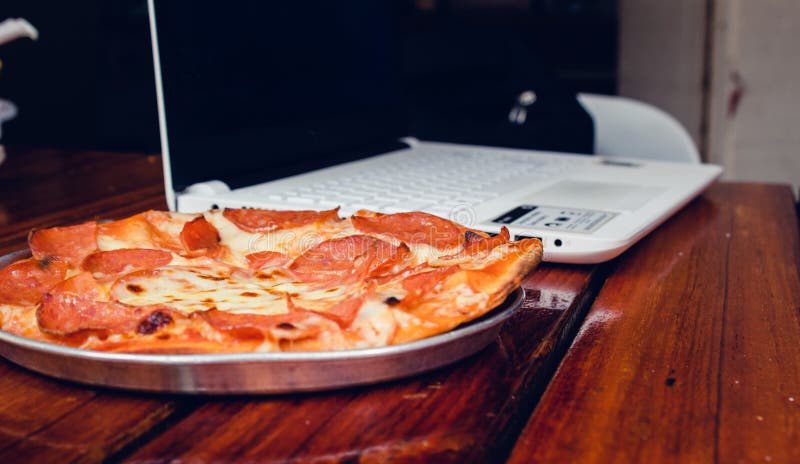Pizza on Table with Laptop in Restaurant Stock Photo - Image of lunch ...