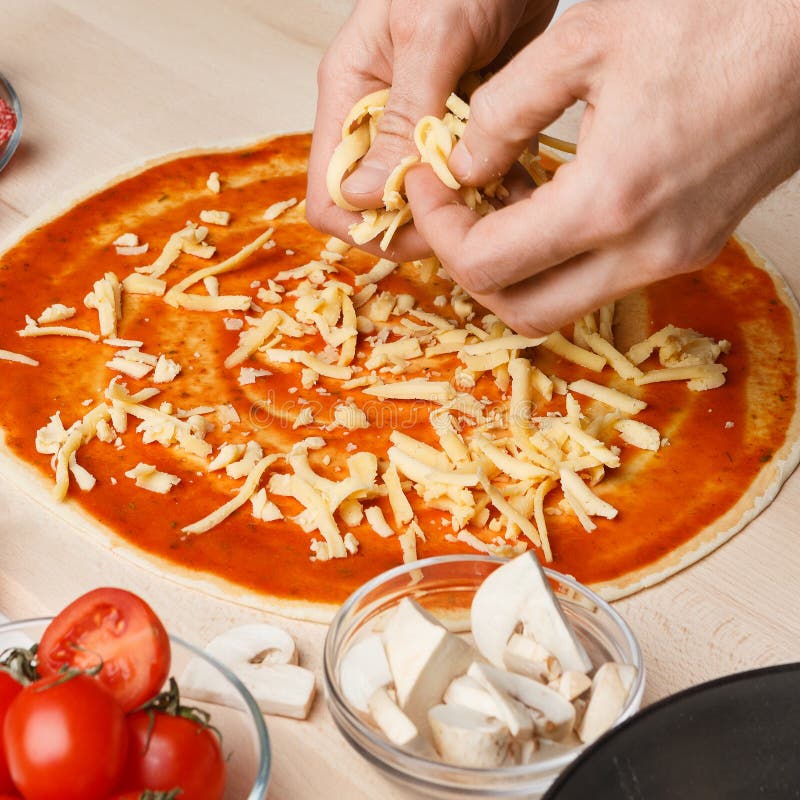 Pizzaiolo Adding Grated Cheese To Pizza Base Stock Image - Image of ...