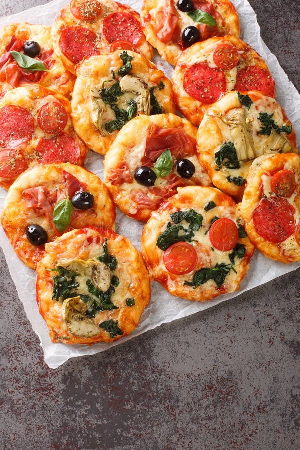Pizzette Small Pizzas with Various Toppings Close-up on Parchment ...