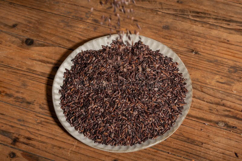 Place the Black Rice in the Plate or Bowl on the Wood Grain Table Stock ...