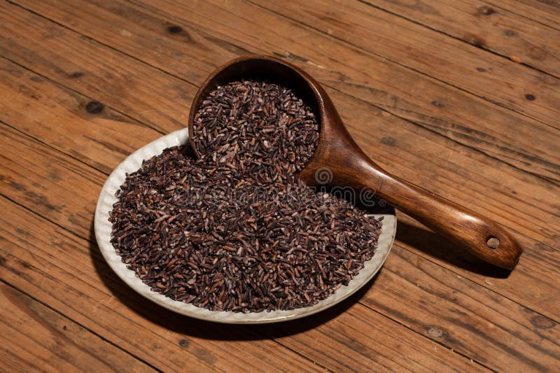 Place the Black Rice in the Plate or Bowl on the Wood Grain Table Stock ...