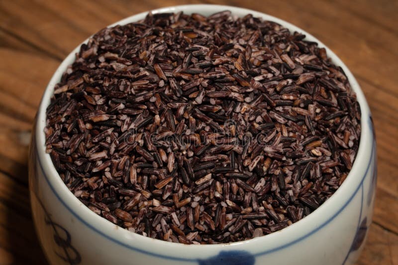 Place the Black Rice in the Plate or Bowl on the Wood Grain Table Stock ...