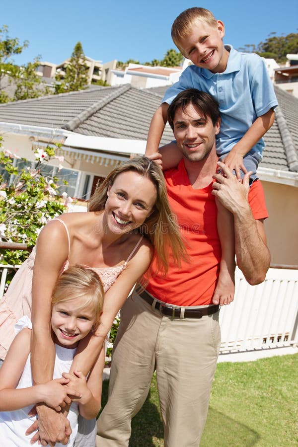 The Place they Call Home. Portrait of a Loving Family of Four Standing ... The Place they Call Home. Portrait of a Loving Family of Four Standing ...