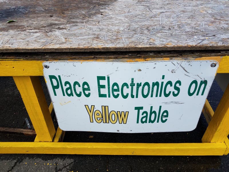 Place Electronics on Yellow Table Sign with Table at Recycling Center ...