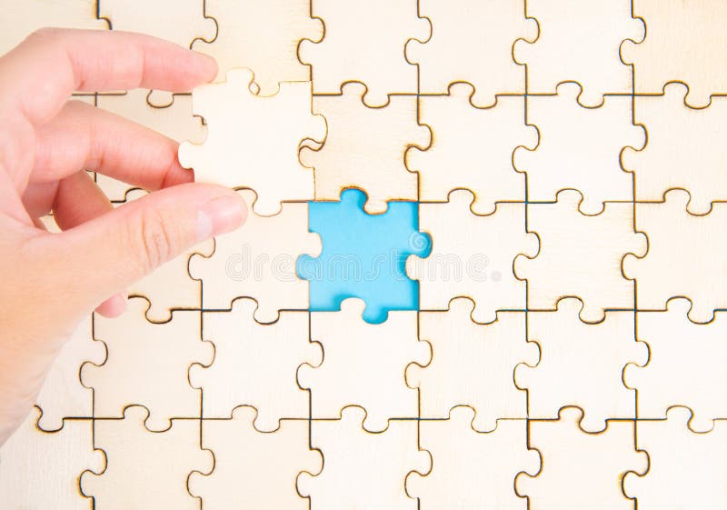 Placing the Final Piece of a Jigsaw Puzzle Stock Photo - Image of group ...