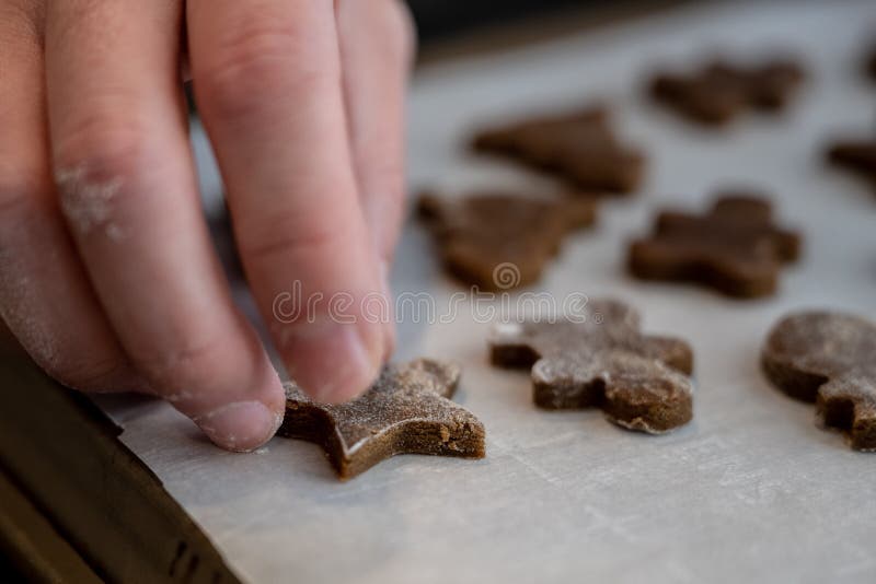 Placing a Tiny Gingerbread Star Onto a Baking Sheet Stock Image - Image ...